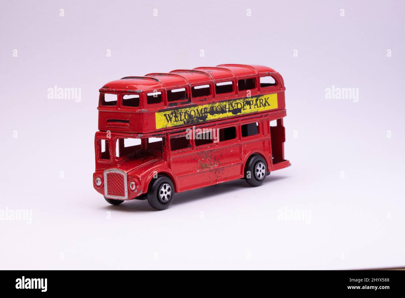 Old used model of a red double-decker with a sign Welcome to Hyde Park ...