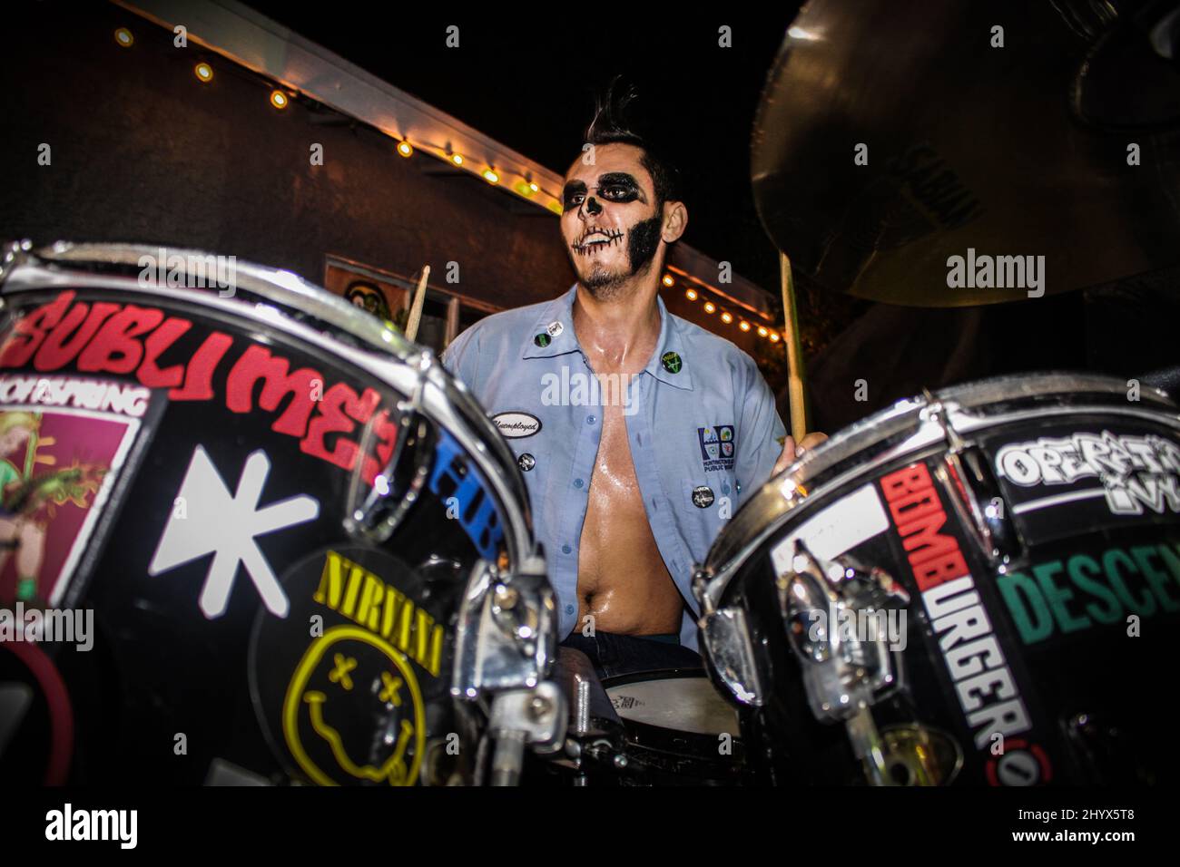 Punk drummer with skeleton face paint playing a Halloween concert at a ...