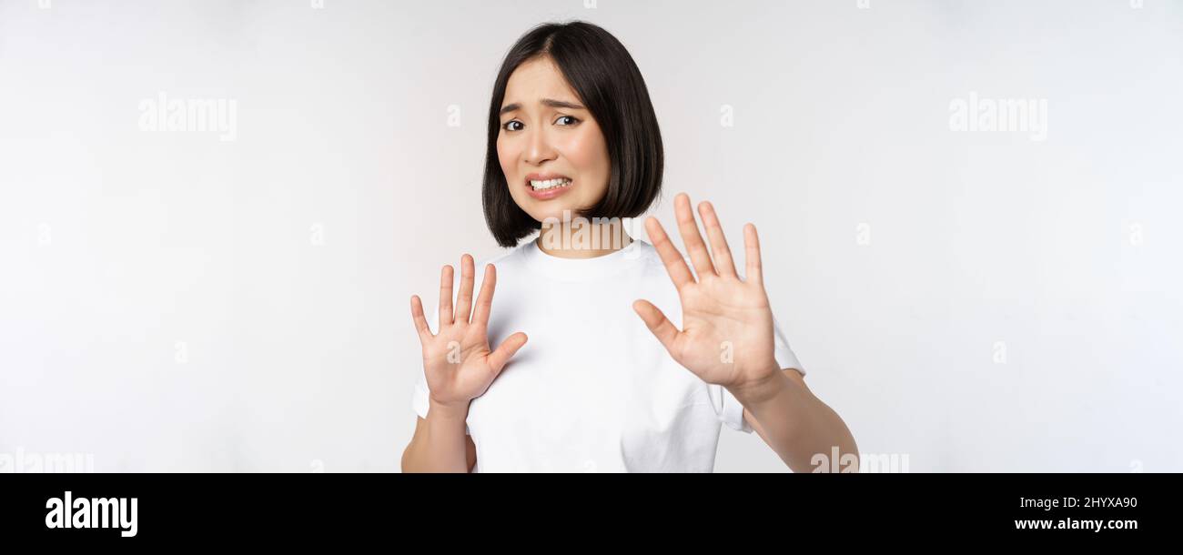 Disgusted asian woman rejecting smth, grimacing from dislike and ...