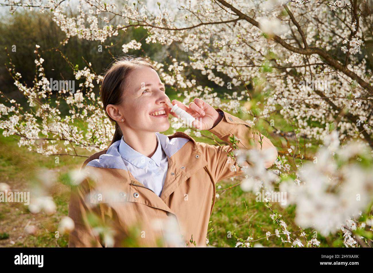 Woman allergic suffering from seasonal allergy at spring, posing in ...