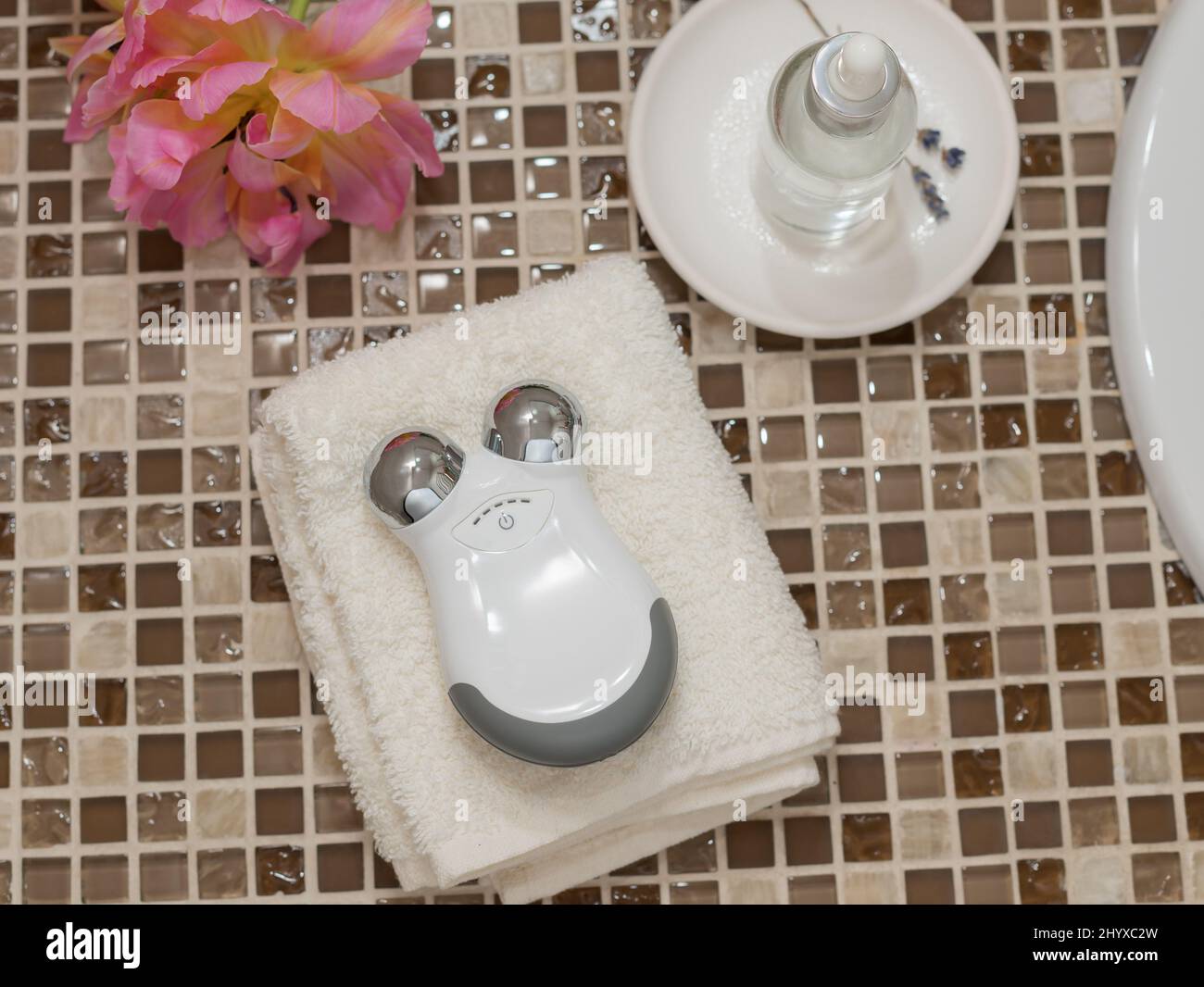 microcurrent facial toning device on mosaic bathroom countertop Stock ...