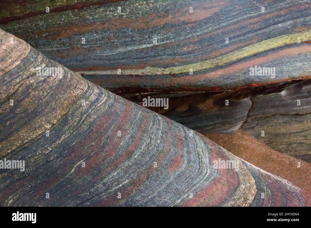 Abstract photograph of colourful patterned rocks, showing detail of the ...