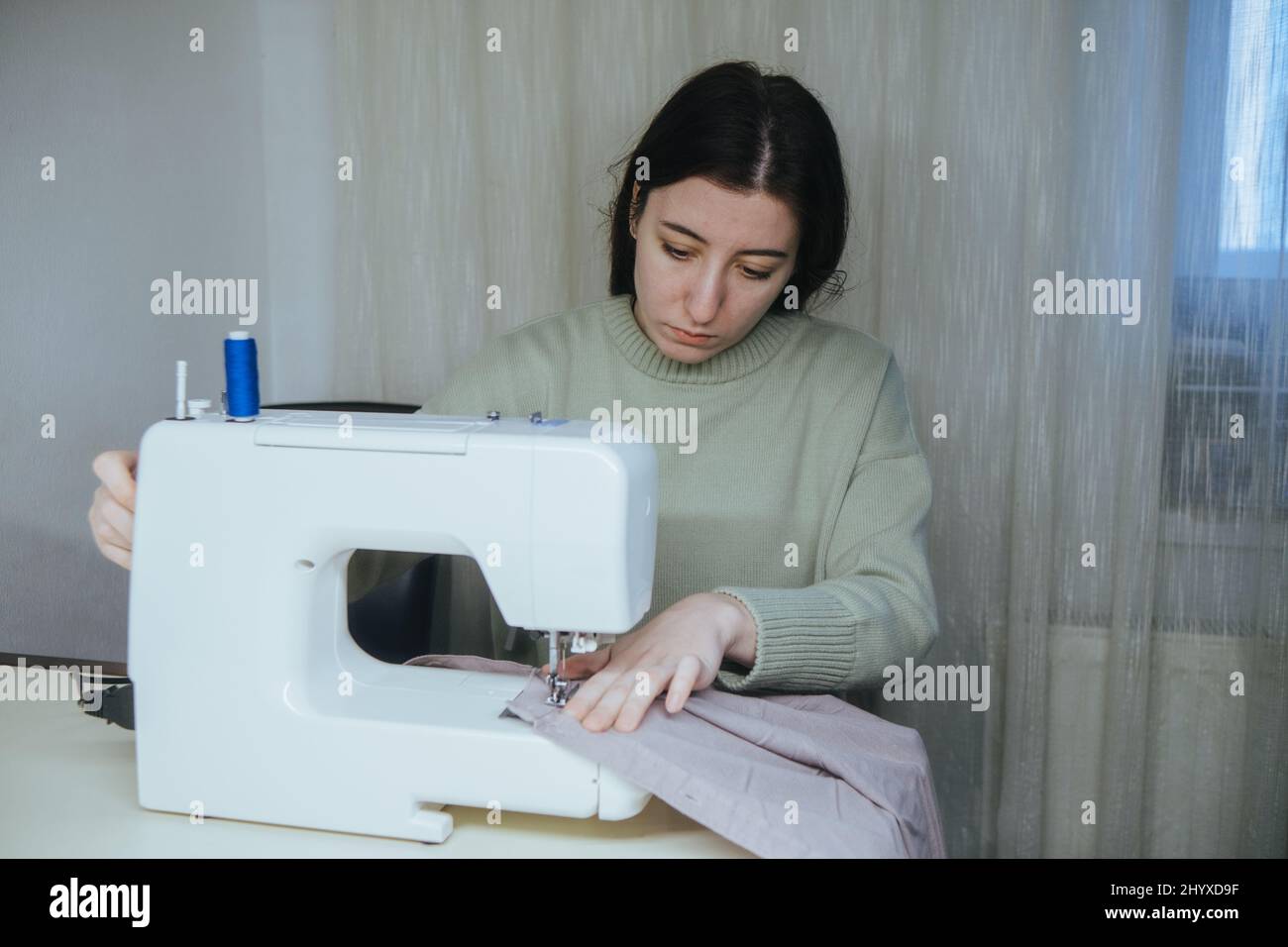 Woman sews sewing machine home hi-res stock photography and images - Alamy
