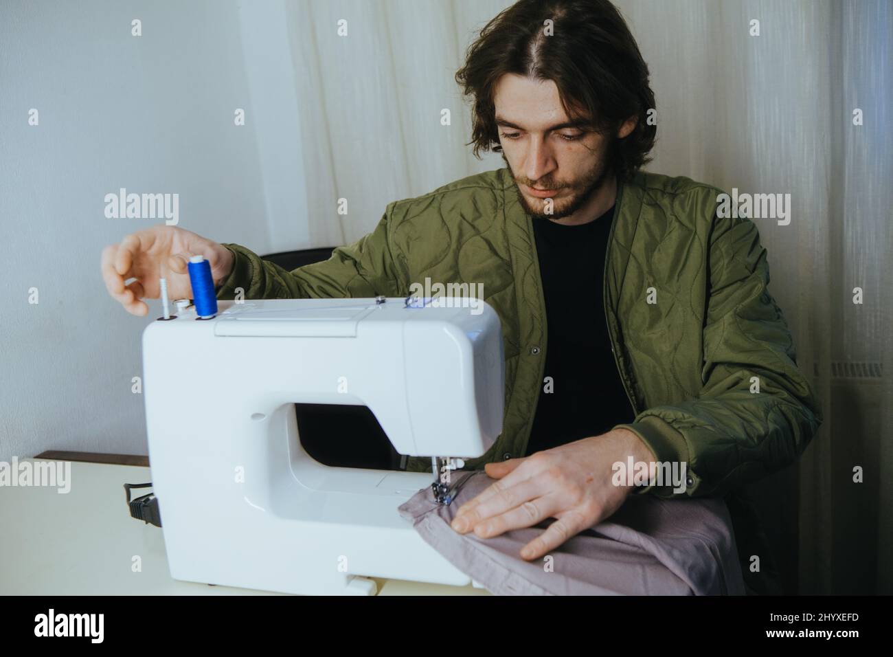 Man sewing home hi-res stock photography and images - Alamy
