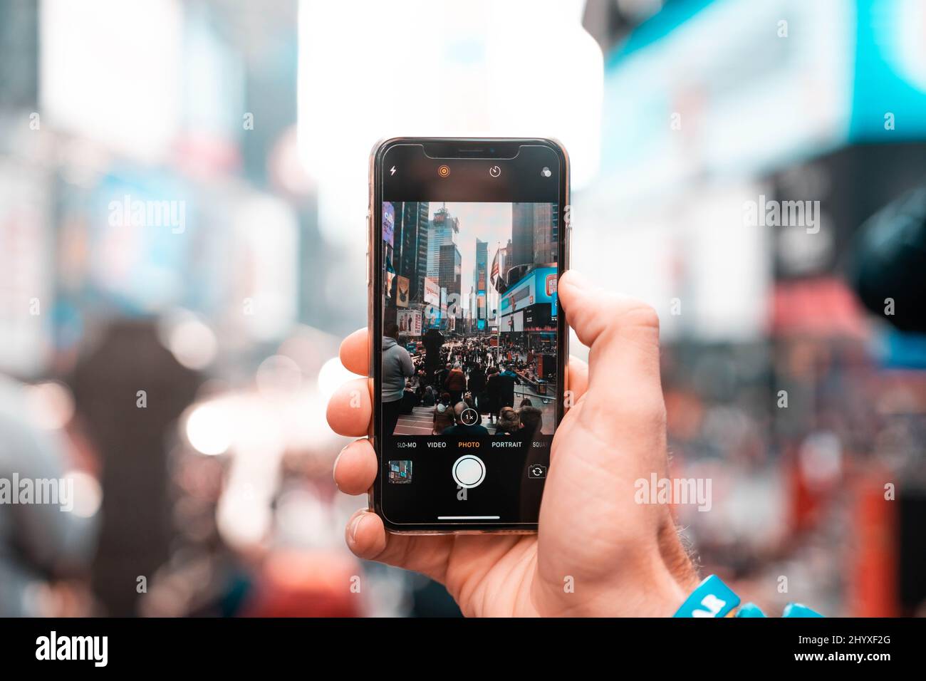 Selective of a man hand holding a phone taking a picture of Times ...
