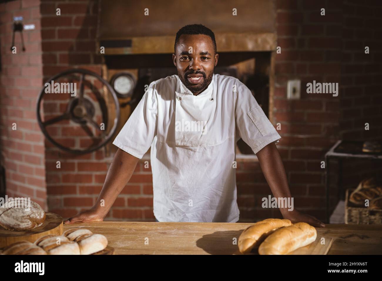 Portrait of confident smiling mid adult african american male baker ...