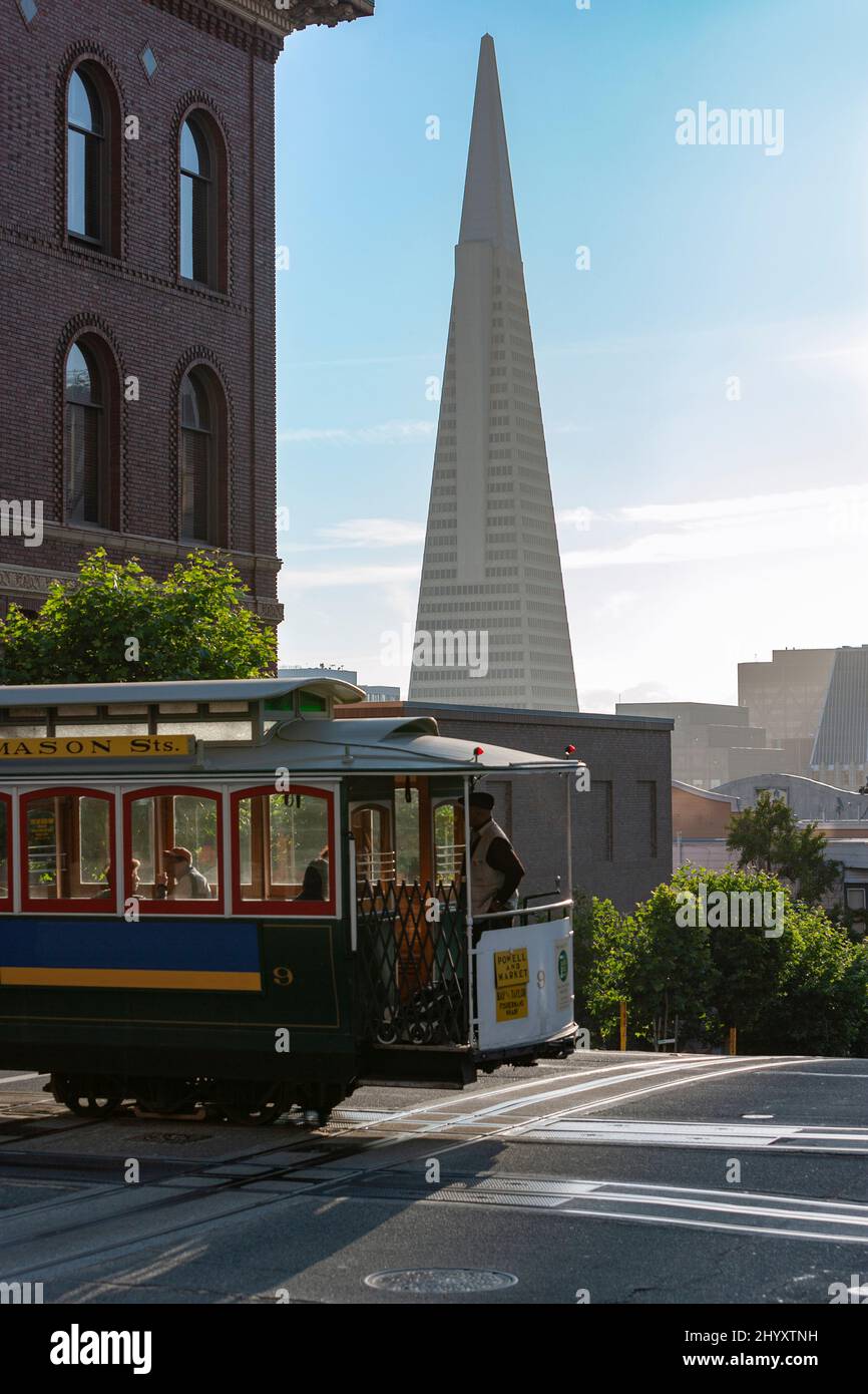 Cable car in the street and transamerican building, San Francisco ...