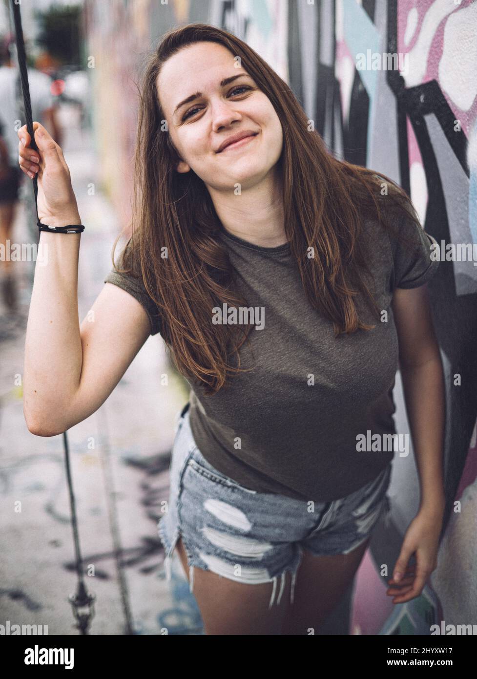 Beautiful female street fashion model poses for the camera in the ...