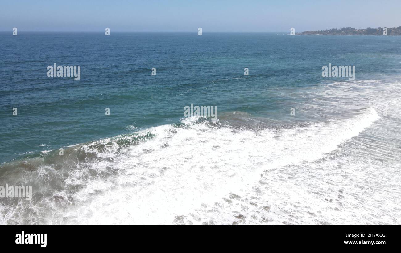Aerial view of the wavy sea hitting the sandy beach on the coast Stock ...