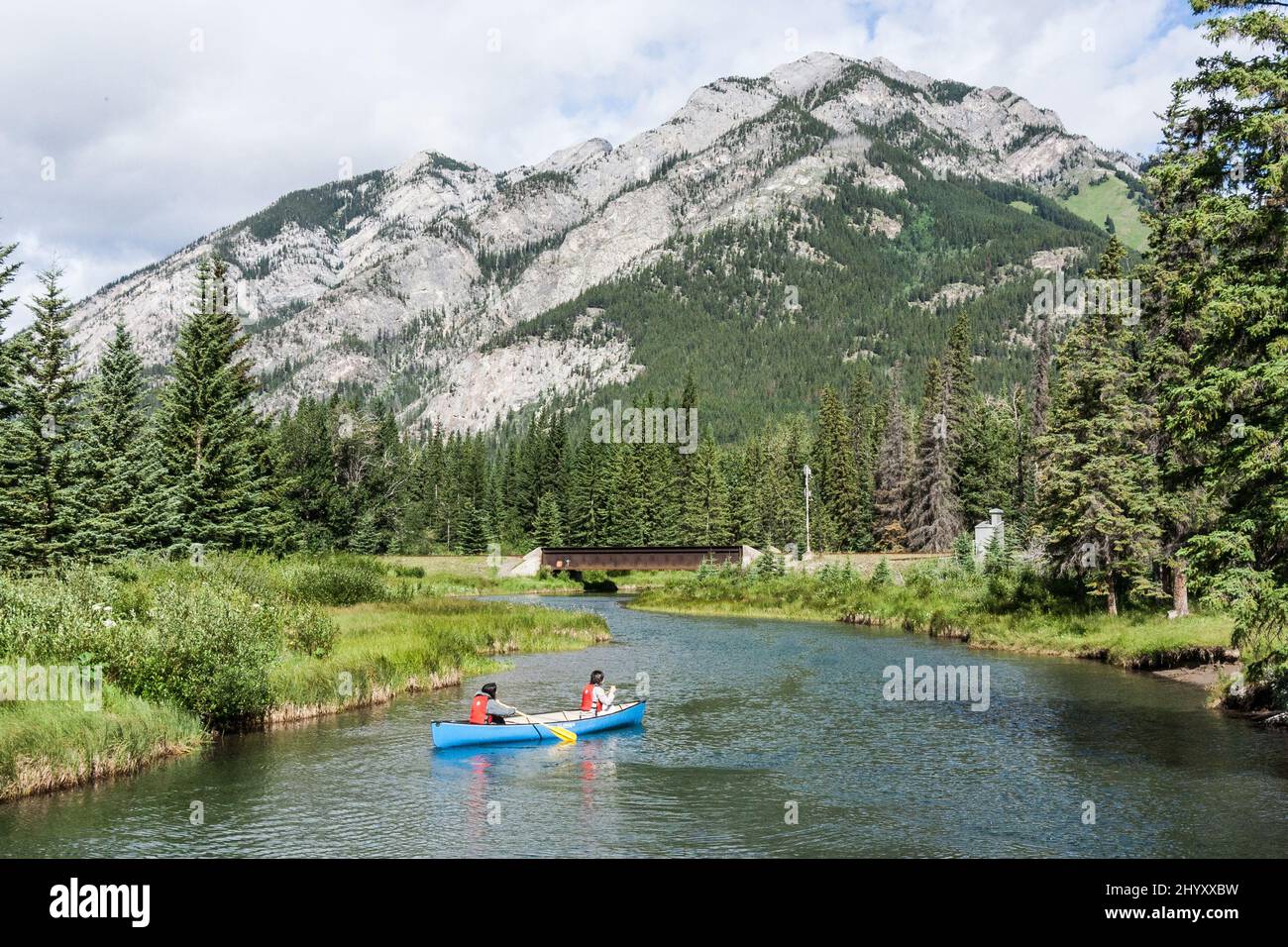 Two people in a canoe paddle down the Bow River in Banff, Alberta ...