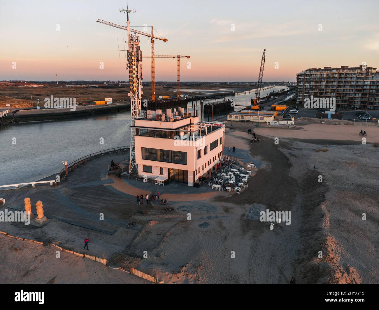 Aerial view of a construction site on the side of the flowing Yser ...