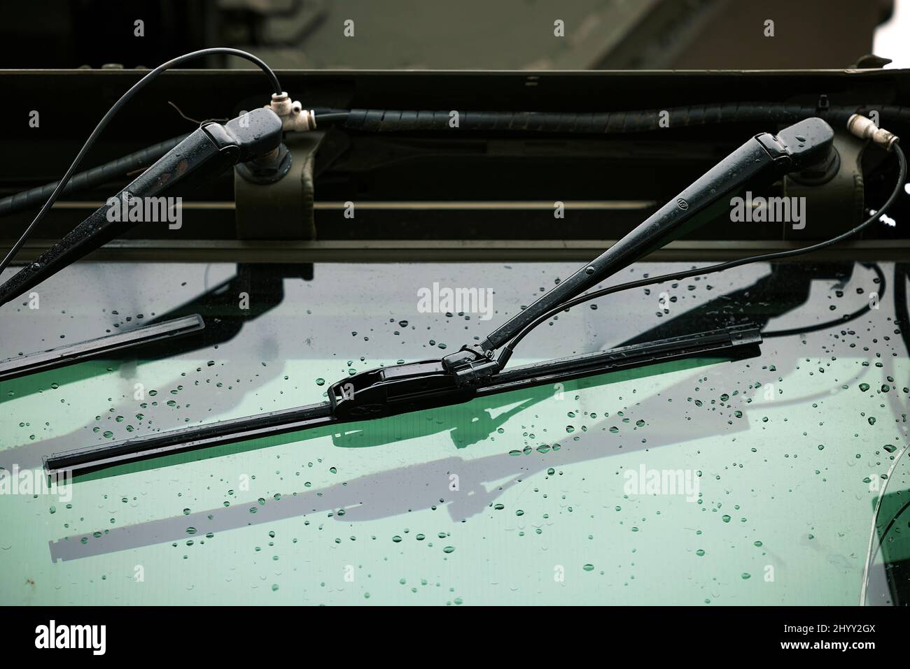 Wipers on the windshield of an armored car. Drops on the windshield ...