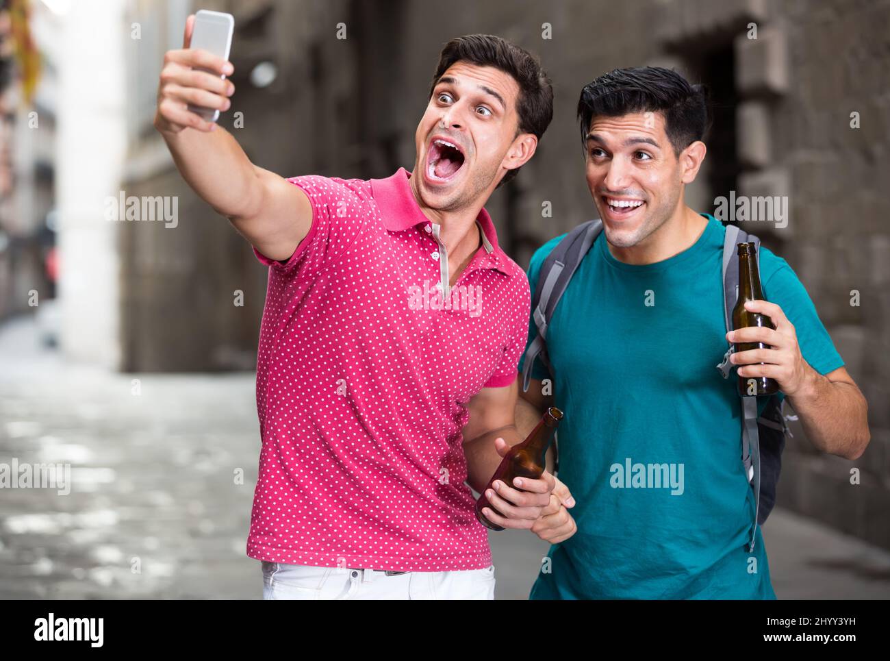 male fans are walking with beer and making selfie near sights in ...