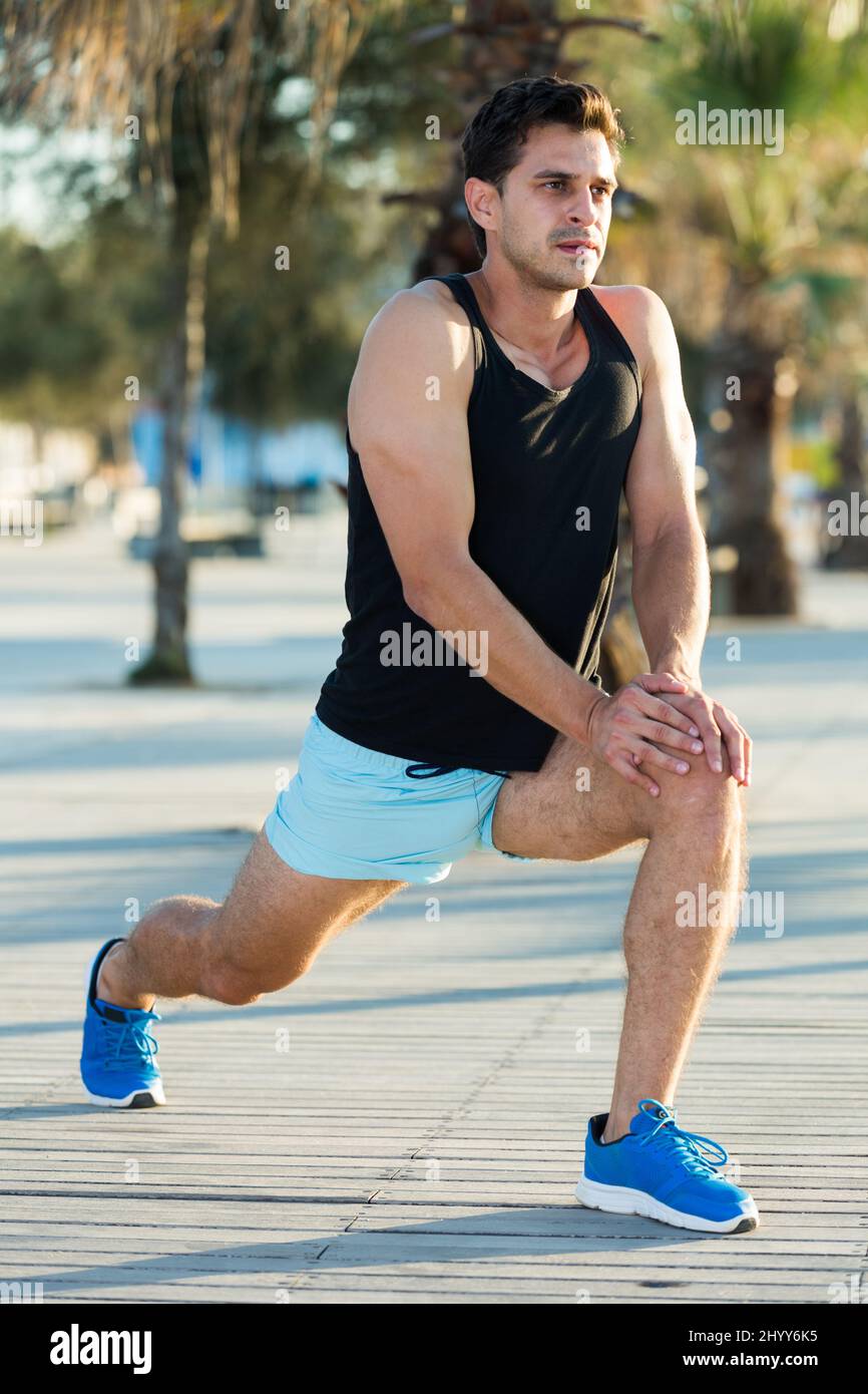 Beach stretching man legs hi-res stock photography and images - Alamy