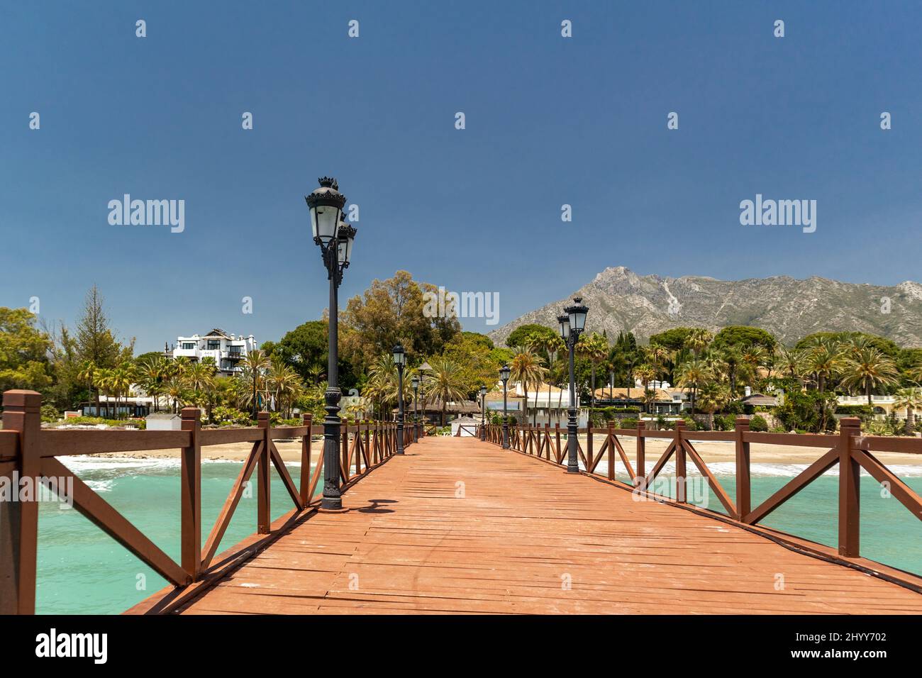 View of red wood bridge "Embarcadero" in Marbella. View of Luxury area ...
