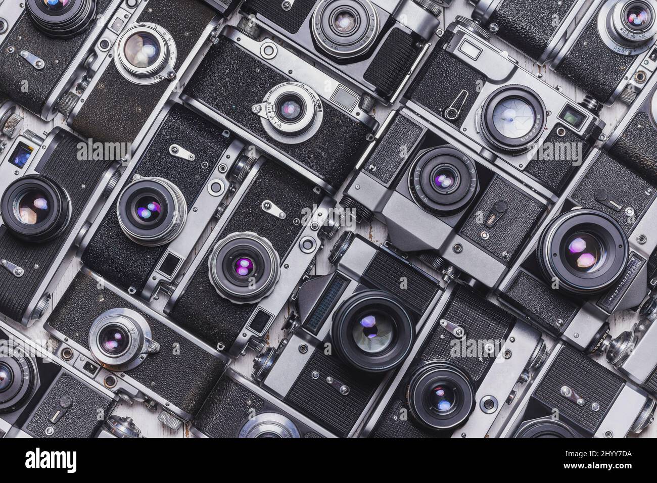 Old retro cameras lie in rows to each other diagonally. View from above ...