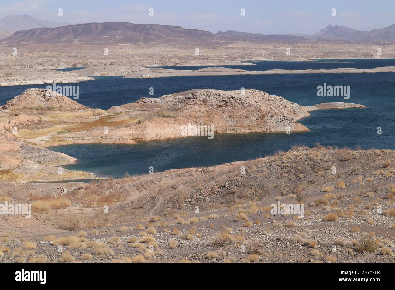 Scenic view of an arid landscape with a blue lake in Lake Mead National ...