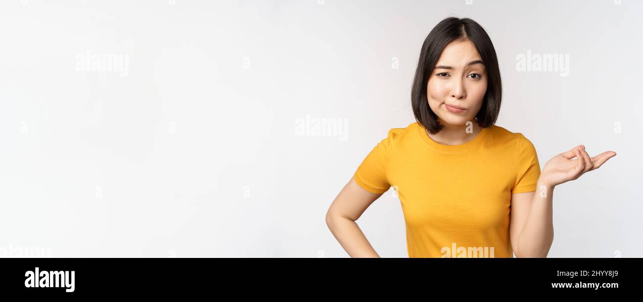 So what. Unbothered asian woman shrugging, looking clueless, standing ...