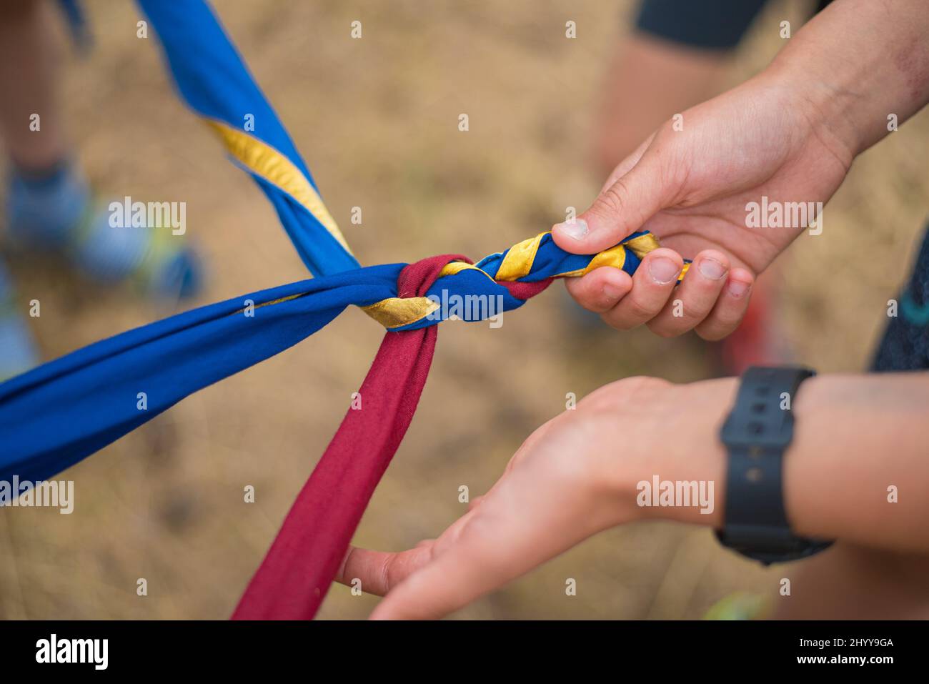 Selective of hands braiding maypole Stock Photo - Alamy