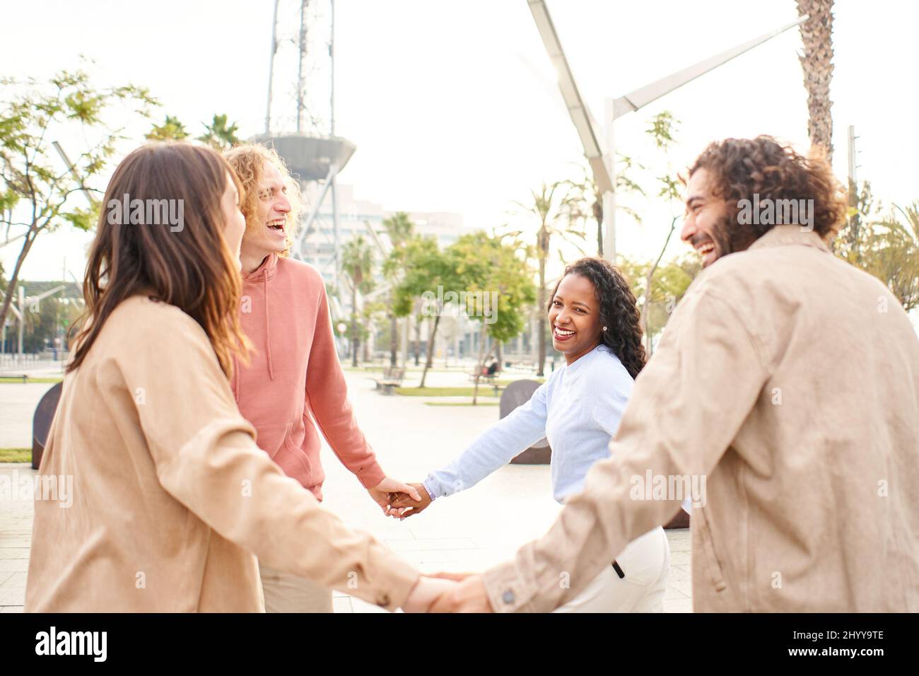 Young group of Friends Outdoors. Embrace People Laughing. Youth Culture ...
