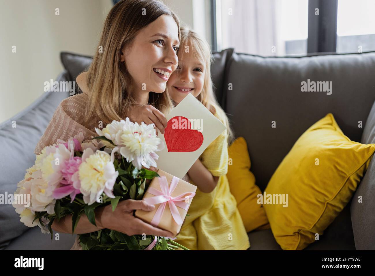 Child daughter congratulates mother and gives present card, gift and ...