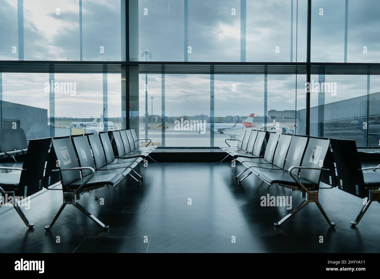 Empty airport terminal lounge with airplane on background. Closed ...
