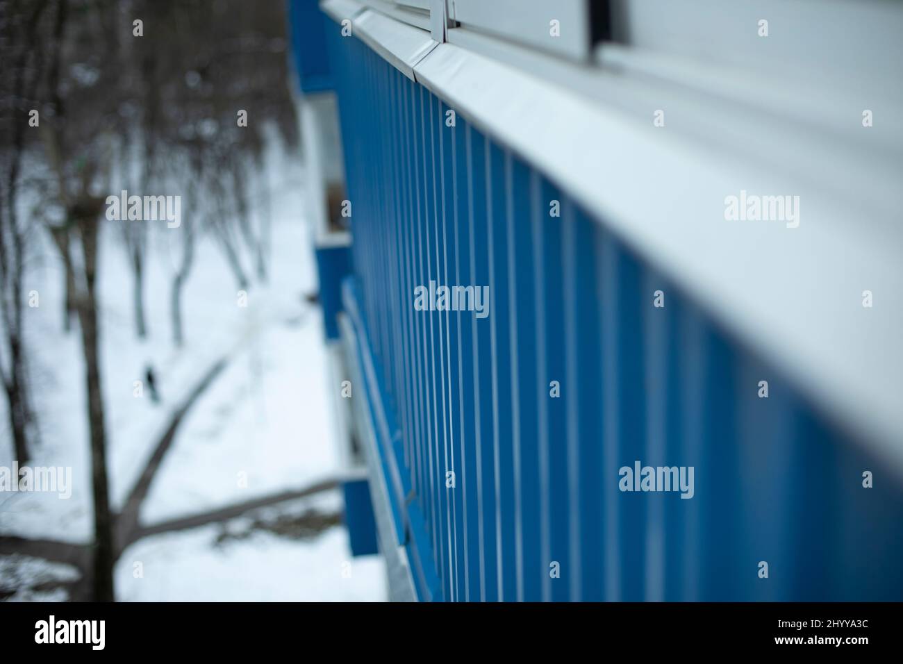 Balcony cladding. Exterior details. White cornice. Ribbed profile leaf ...