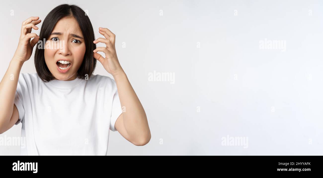 Korean woman freaking out, shaking hands and shouting in panic ...