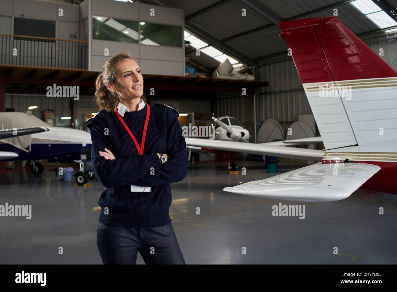 Young pilot posing smiling in the hangar surrounded by airplanes Stock ...