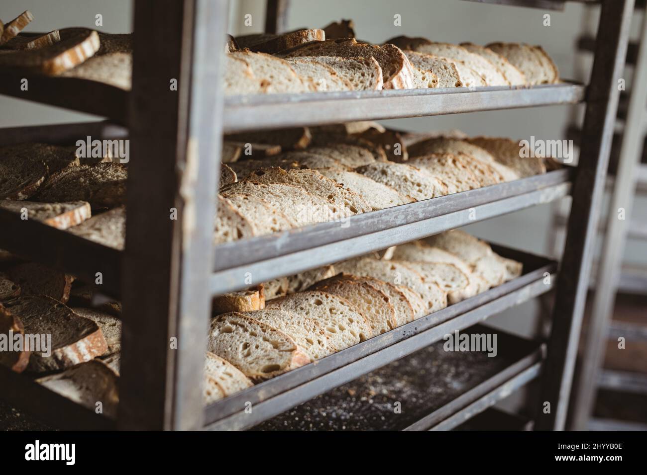 Close-up of bread slices in tray on rack in bakery Stock Photo - Alamy