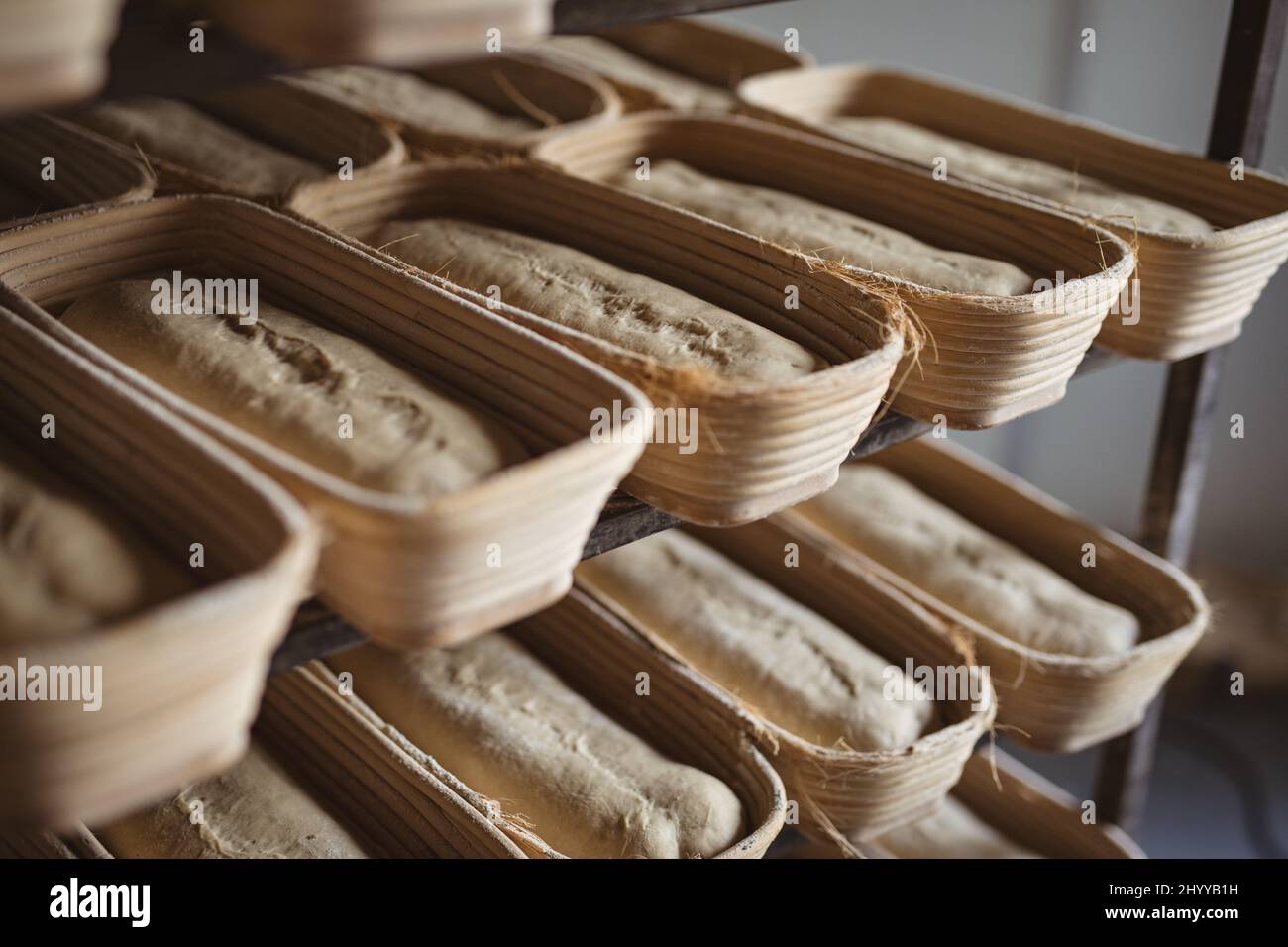 High angle view of dough in container on rack in bakery Stock Photo - Alamy