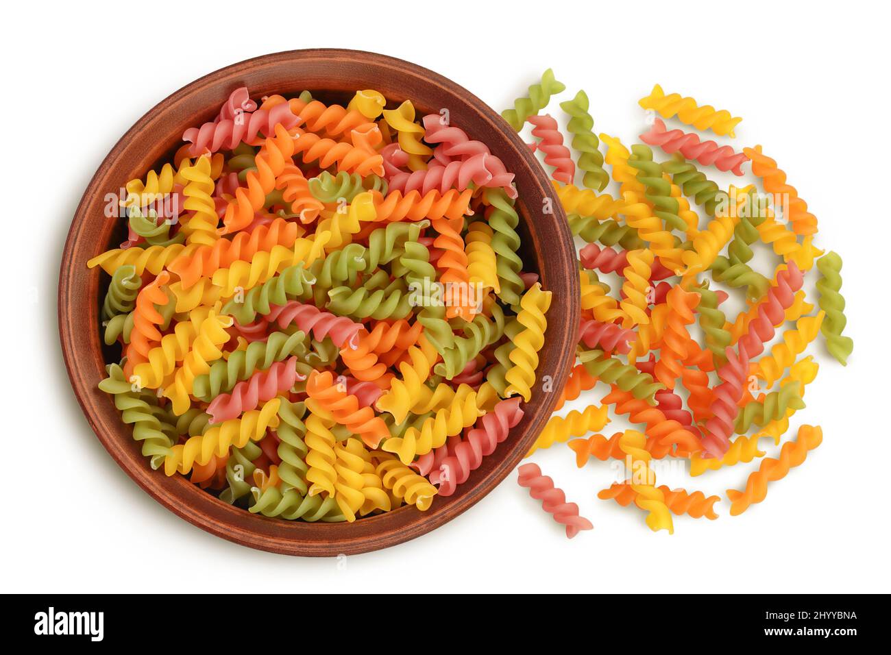 raw Fusilli colored pasta in ceramic bowl isolated on white background ...