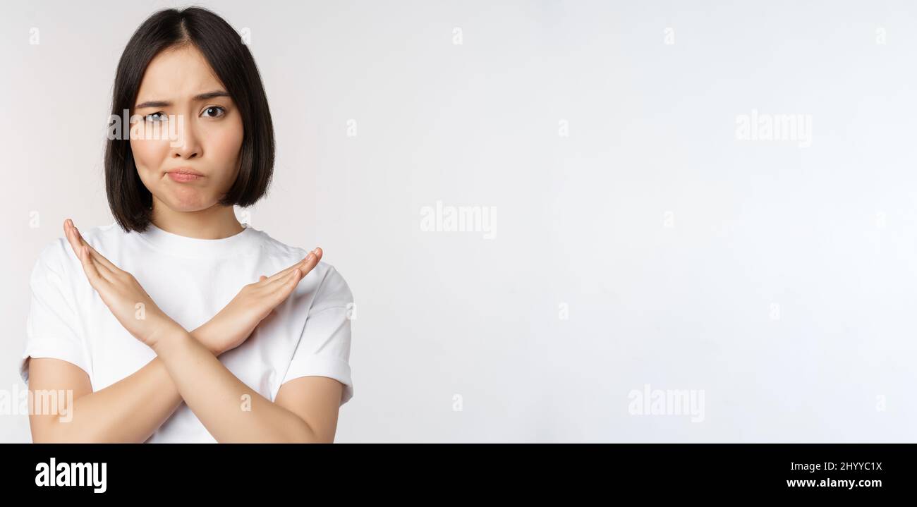 Portrait of asian korean woman showing stop, prohibition gesture ...