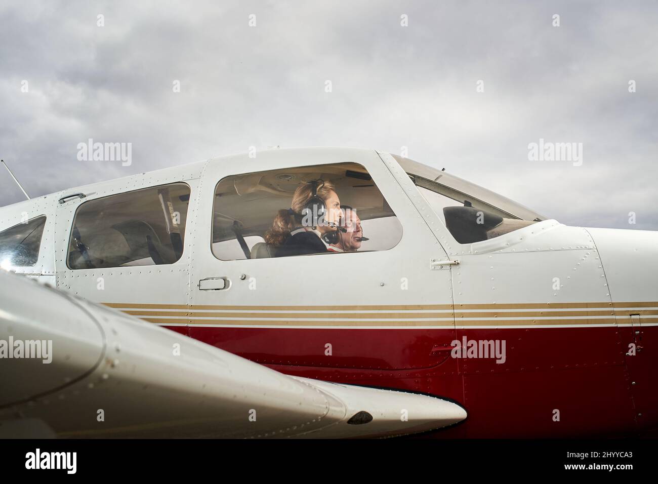 Plane in flight. Female flight instructor giving flight lessons to a ...