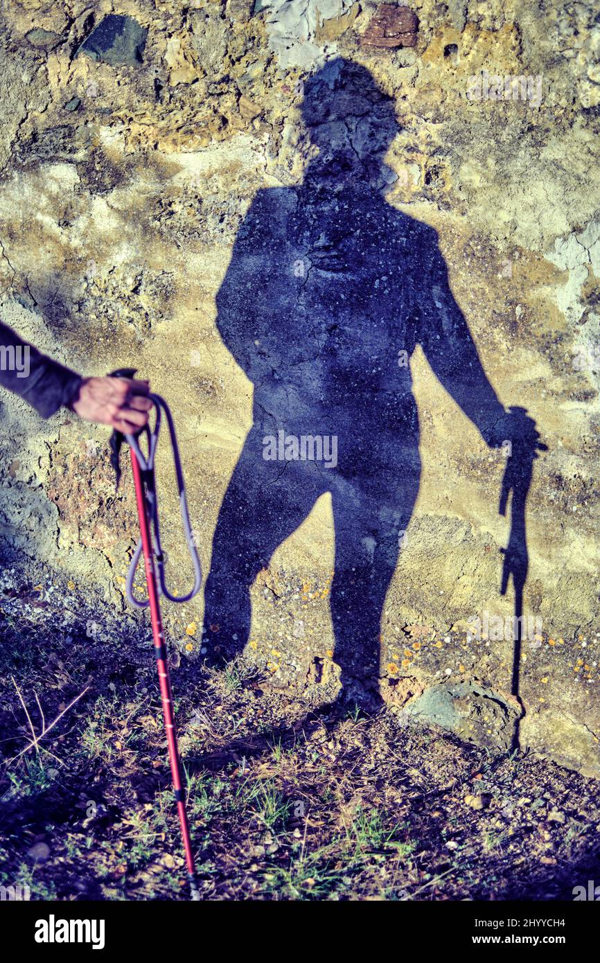 Portrait of a young mature caucasian woman standing with a trekking ...