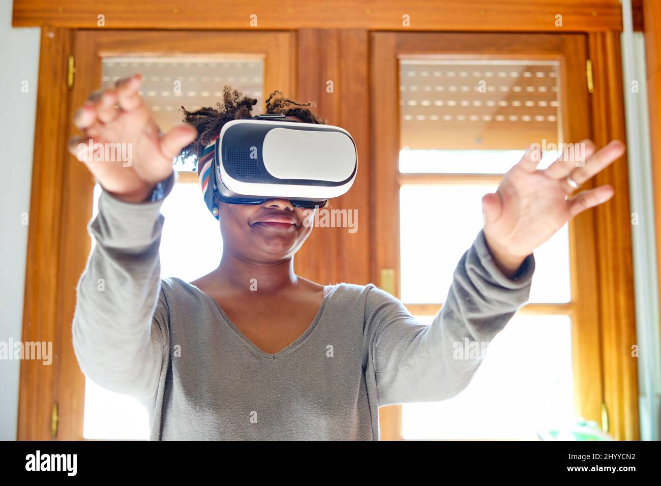 Portrait of an active young black woman testing a virtual reality ...