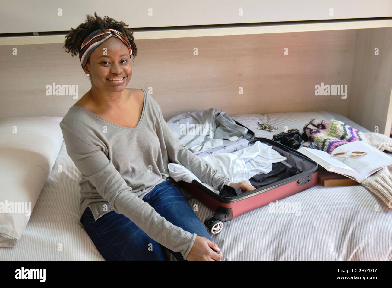 African woman packing suitcase hi-res stock photography and images - Alamy