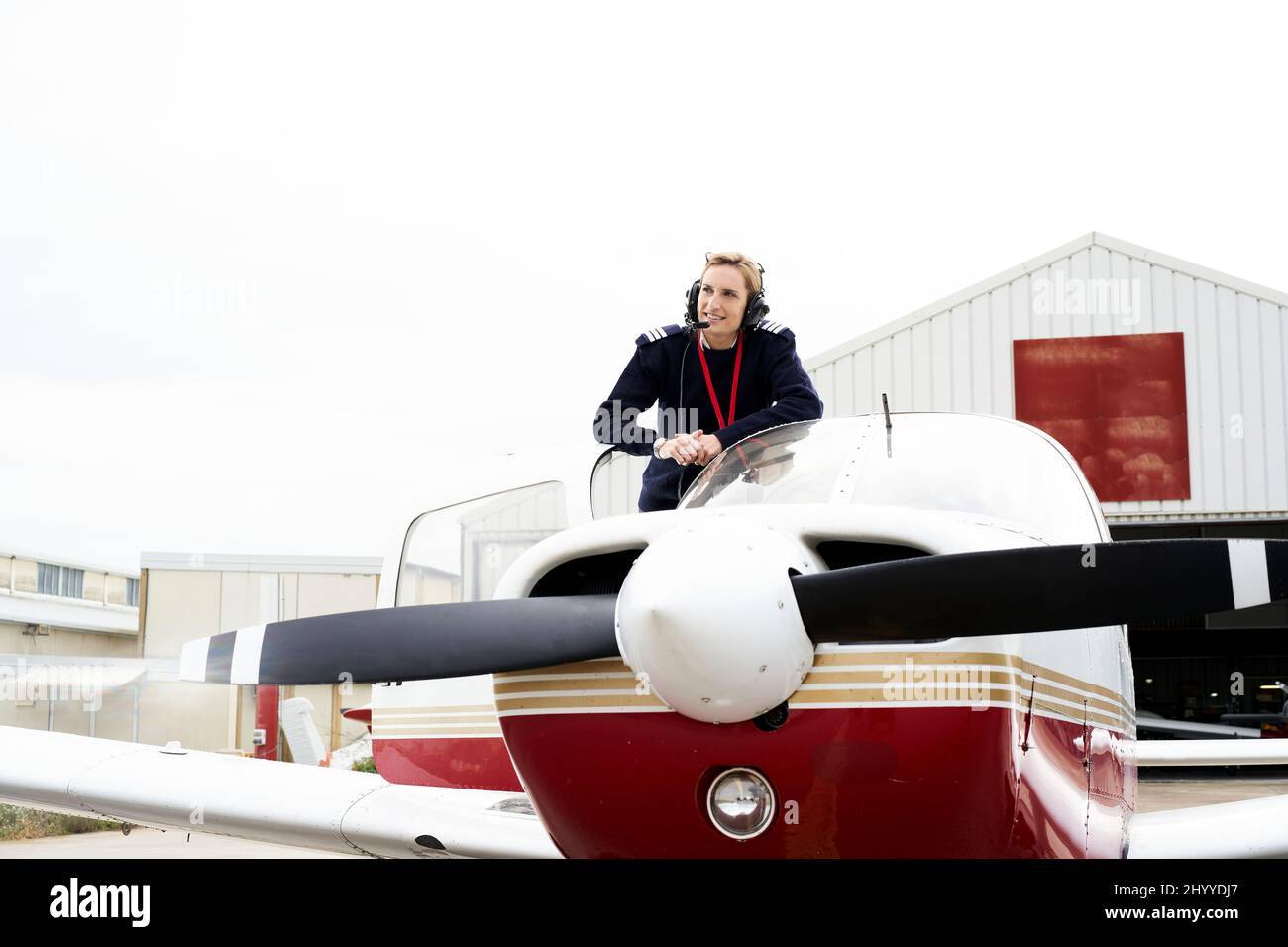 Young female pilot posing on her plane Stock Photo - Alamy