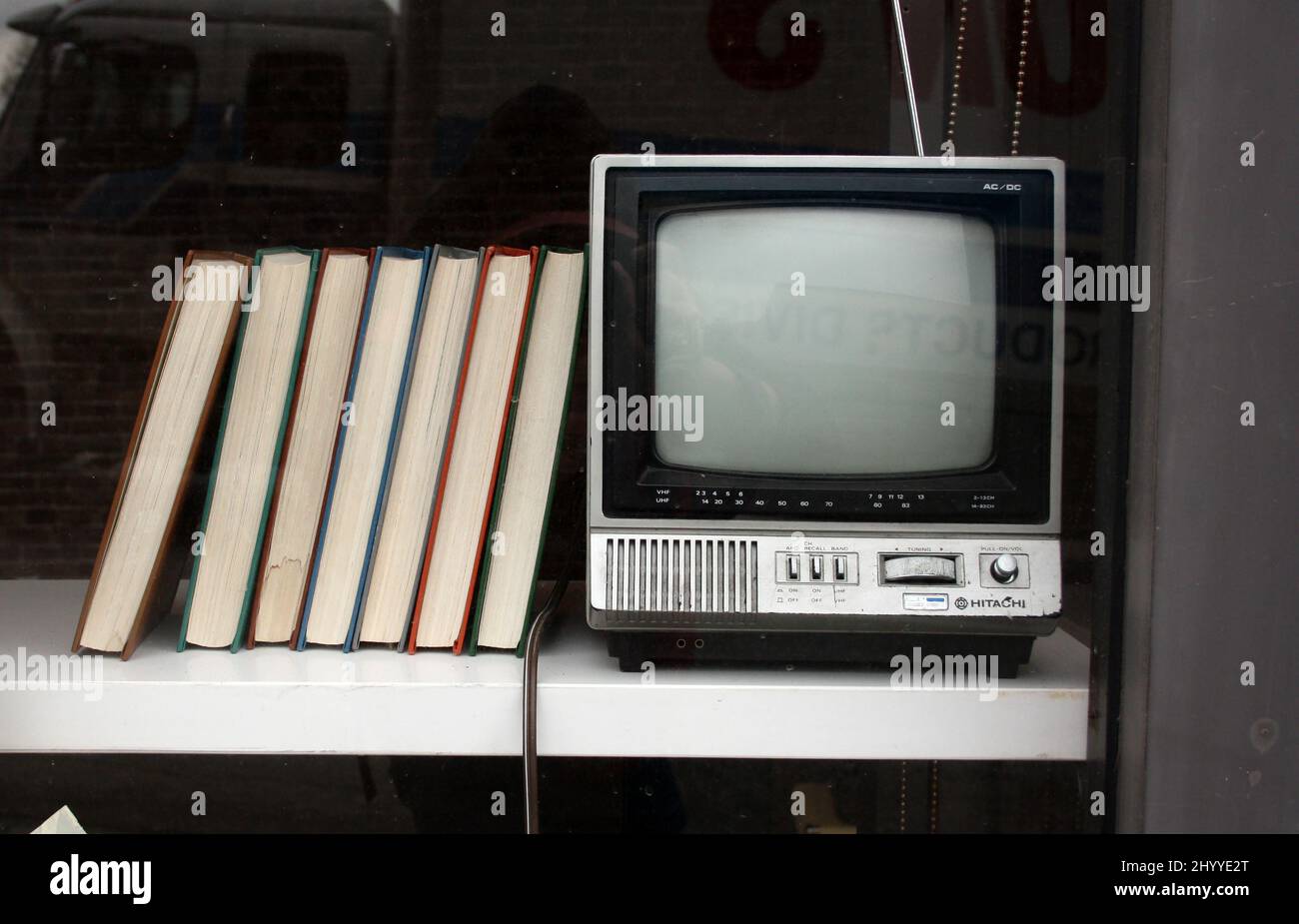Vintage TV set and books in a shop window Stock Photo - Alamy