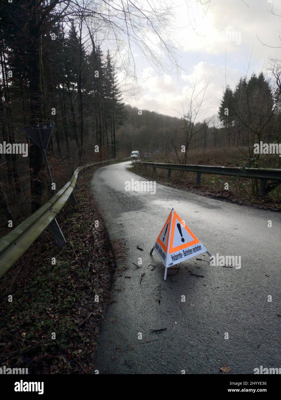 A triangular warning sign on the road Stock Photo - Alamy