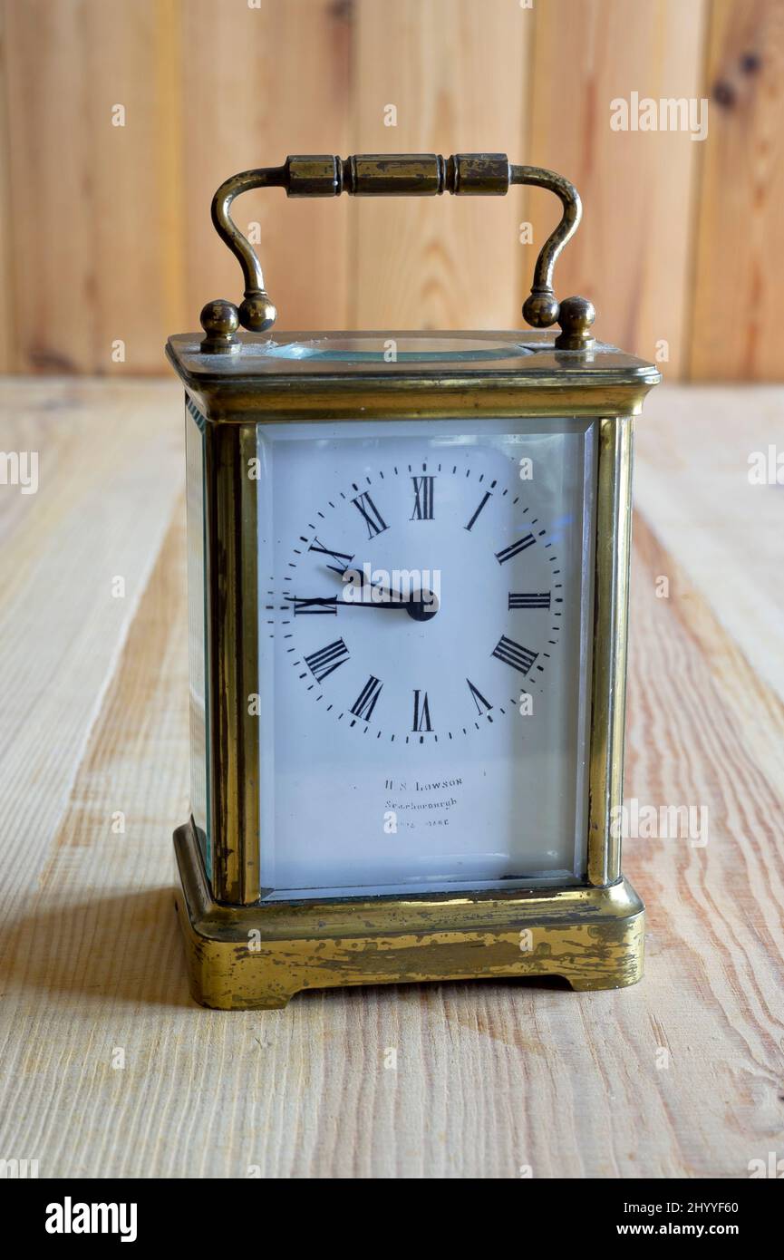 Old carriage clock on a table Stock Photo - Alamy