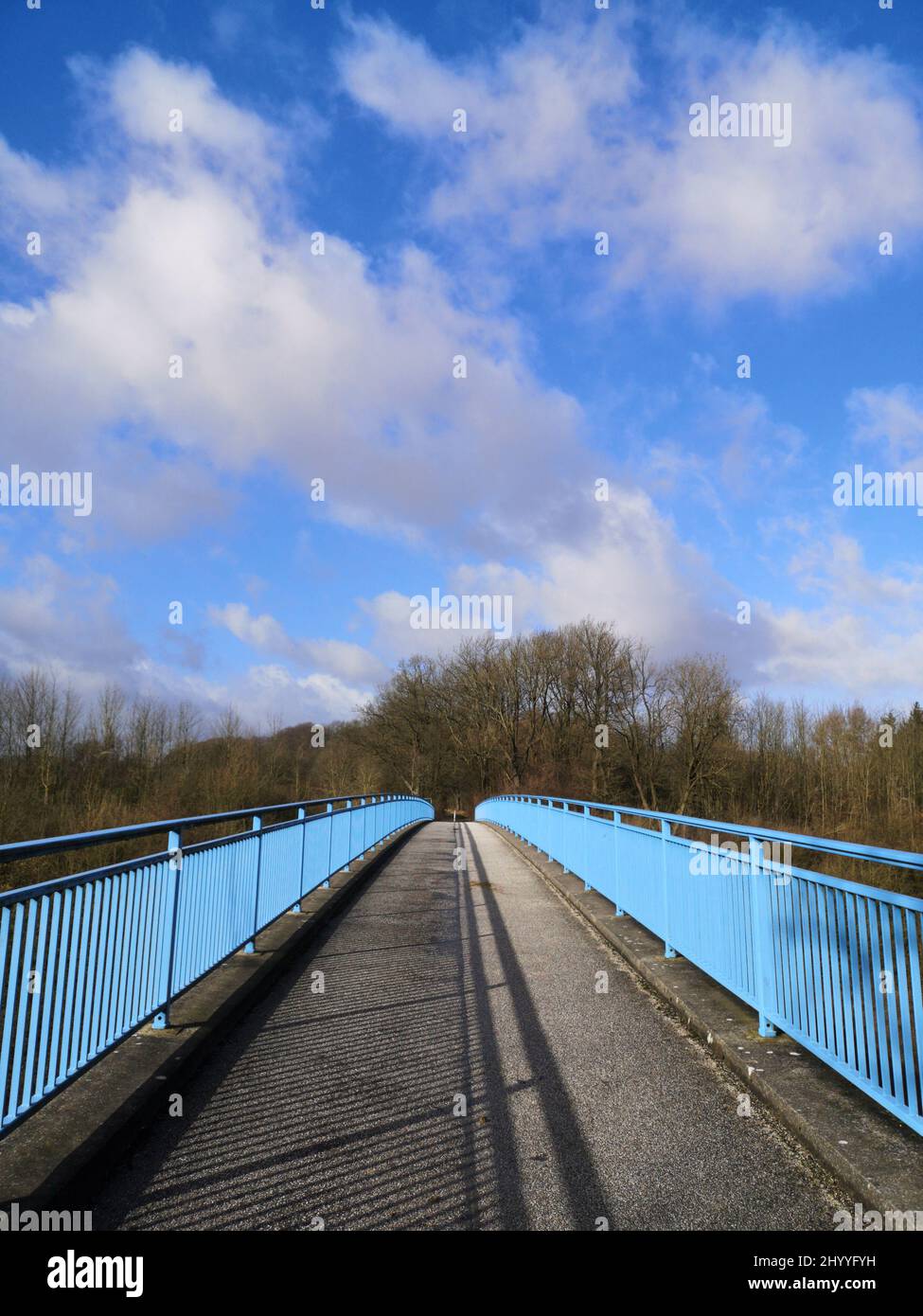Asphalt way on a bridge with blue railings Stock Photo - Alamy