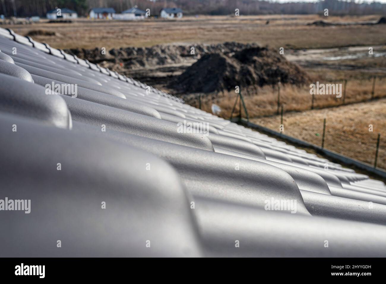 The roof of a single family house is covered with new anthracite ...