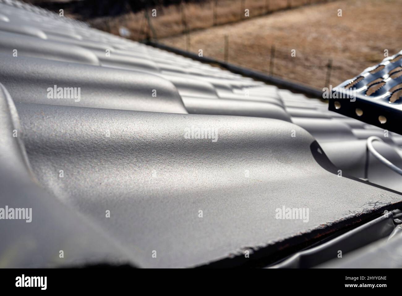 The roof of a single family house is covered with new anthracite ...