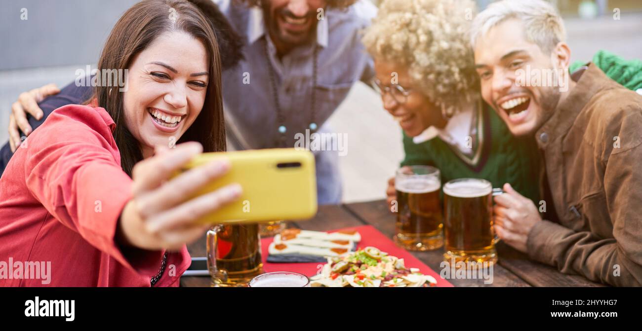 Panoramic photo of a Diverse group of friends taking a selfie at a ...