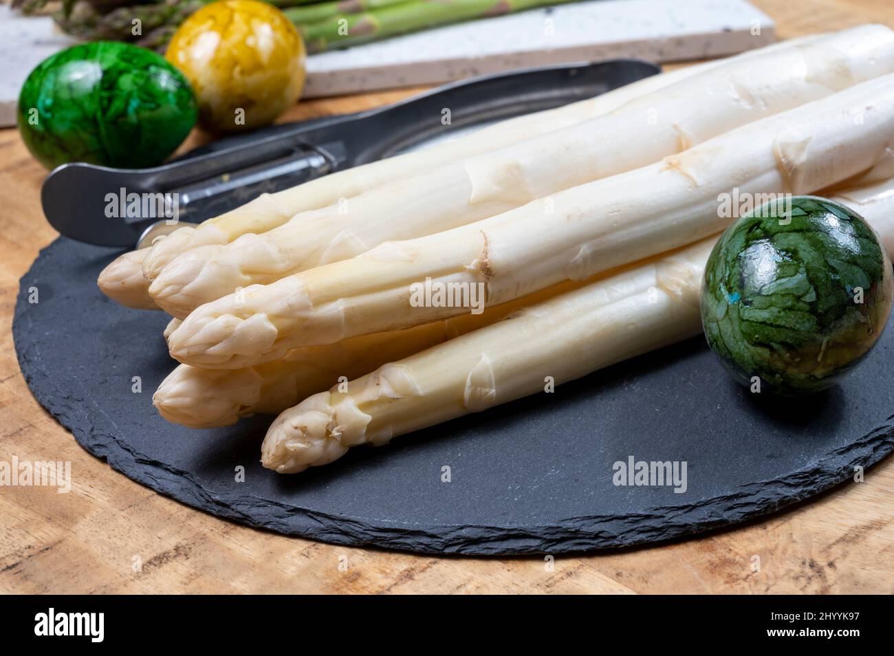 Cooking of fresh white asparagus vegetables, peeler knife for asparagus ...
