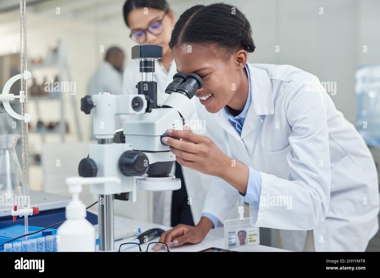 Science allows you to see a lot more. Shot of a young scientist using a ...