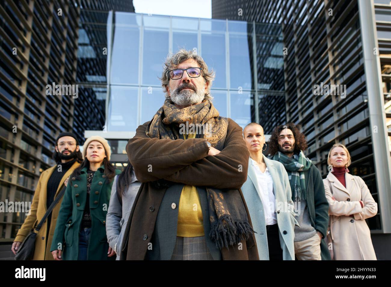 The director of the company poses with his team in front of the ...