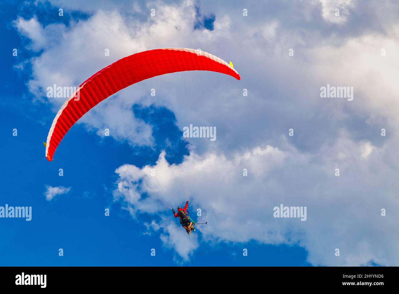 Flying paraglider on a background of blue sky with clouds Stock Photo ...