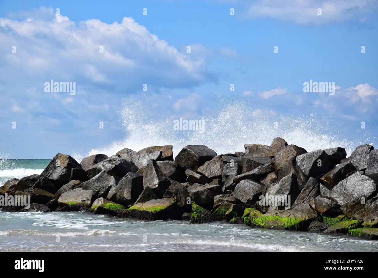 Water splashing over bunch of rocks Stock Photo - Alamy